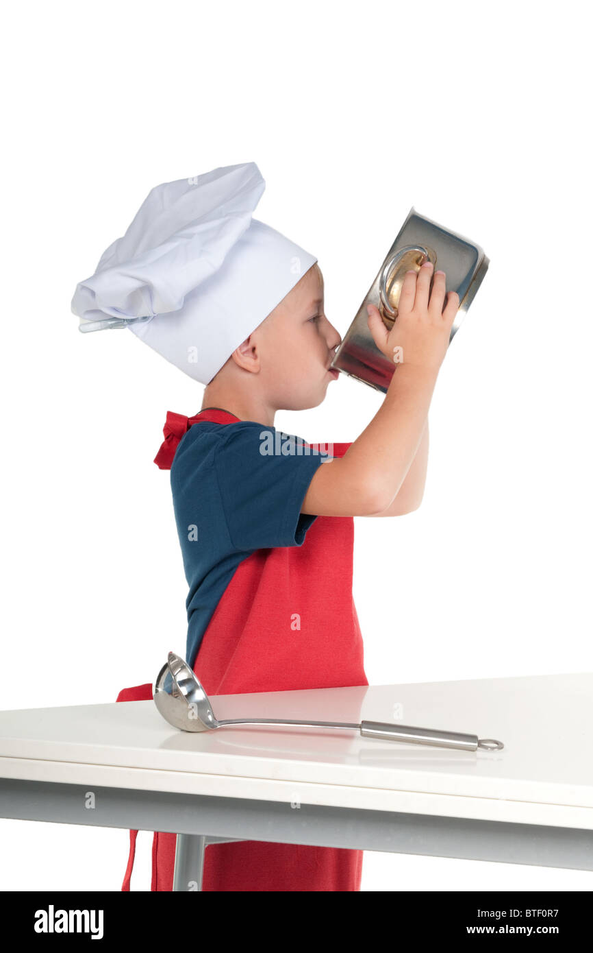 Little boy dressed like a chef tasting the food he made Stock Photo - Alamy