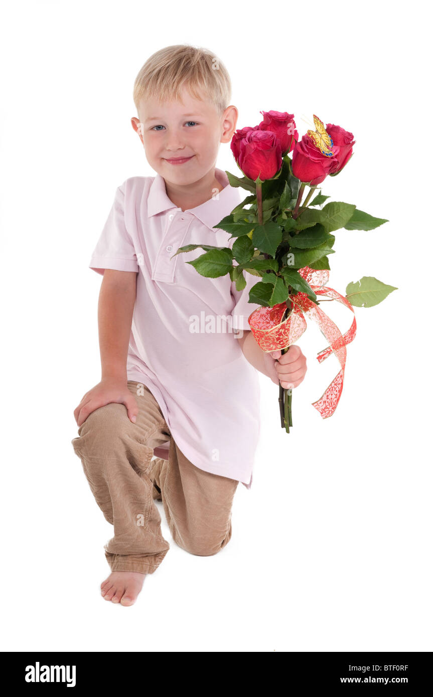 Smiling boy presenting a bunch of red roses Stock Photo - Alamy