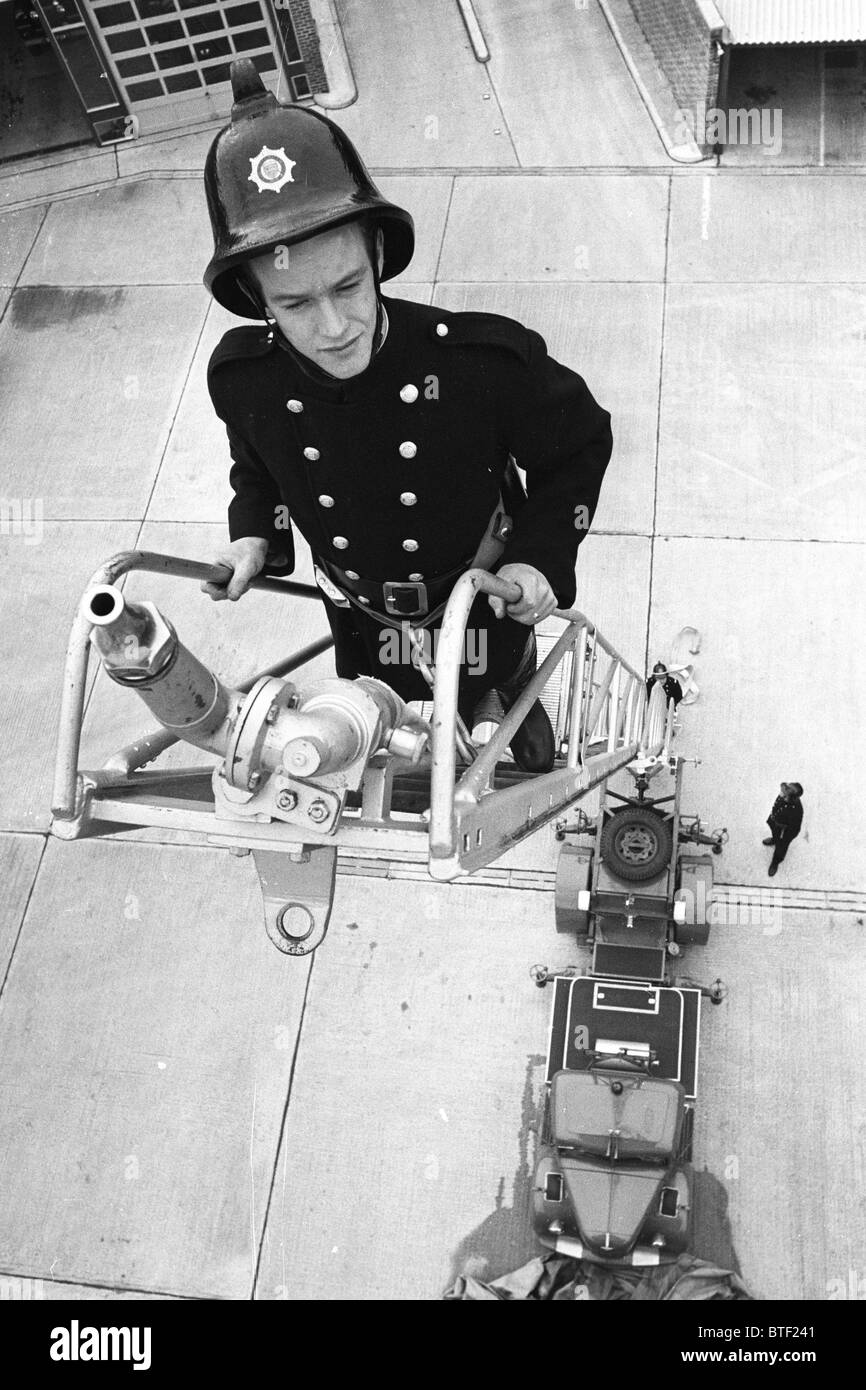 A fireman on a turntable ladder 1960's style UK Stock Photo - Alamy
