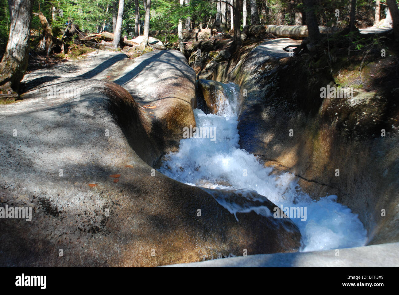 Stream rushing through rocks Stock Photo - Alamy
