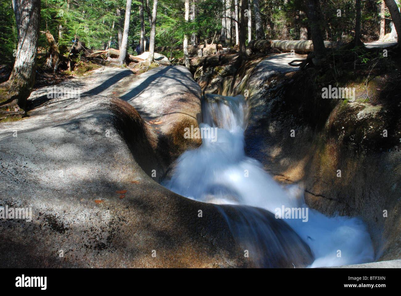 Stream rushing through rocks Stock Photo - Alamy