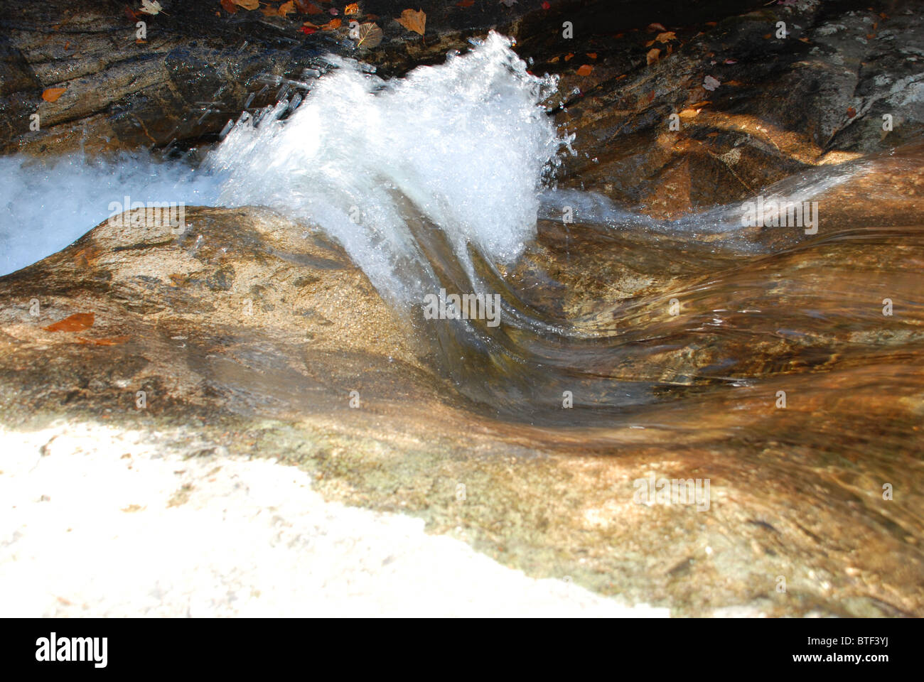 Water rushing over bed rock Stock Photo - Alamy