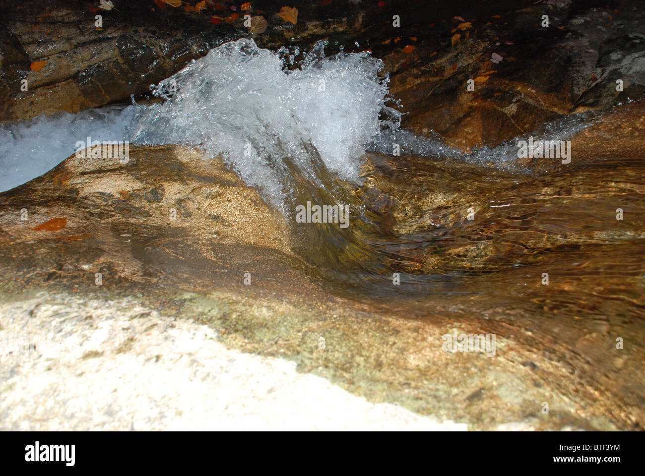 Water rushing over bed rock Stock Photo - Alamy