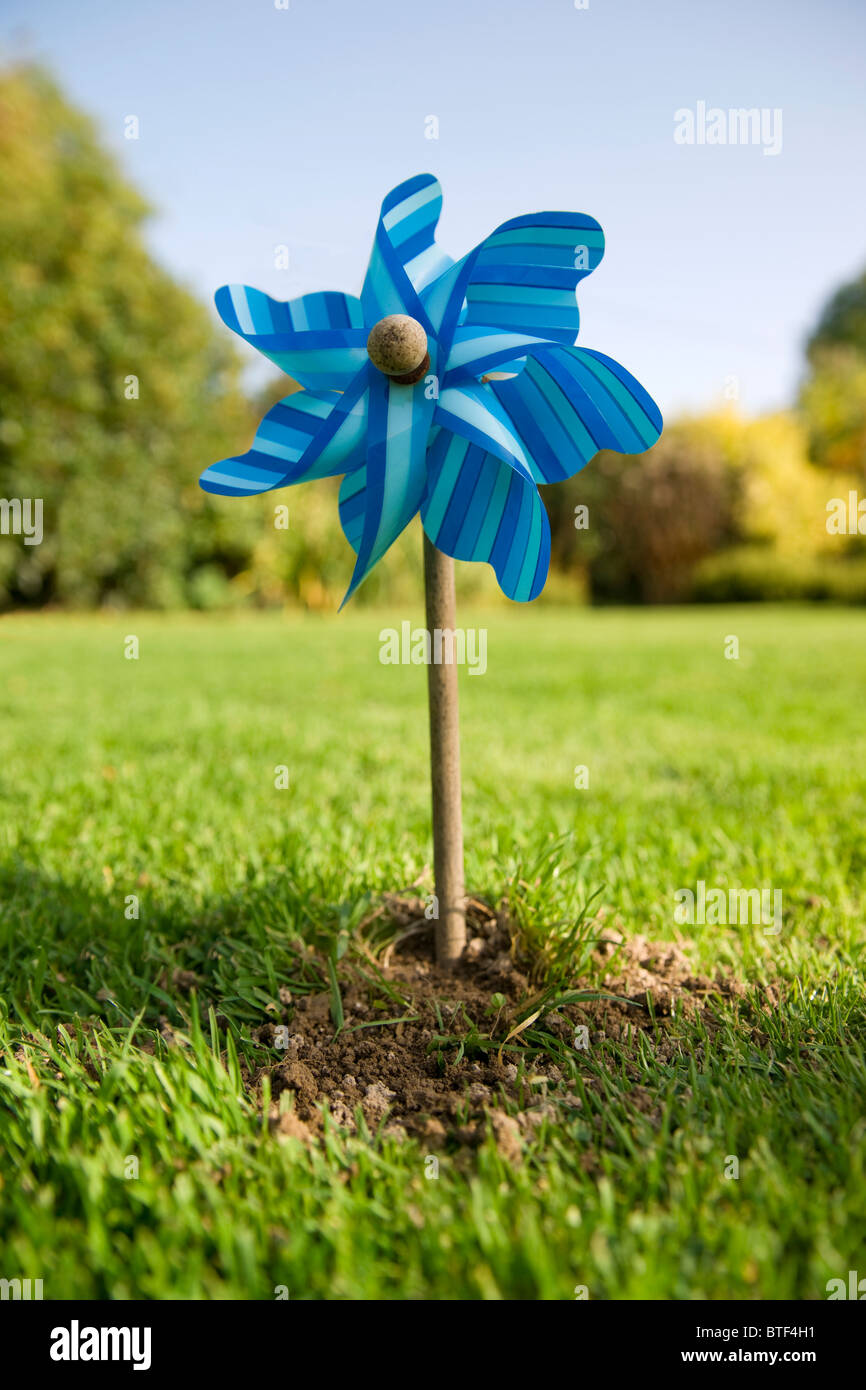 tri coloured blue garden windmill placed in a green lawn Stock Photo ...