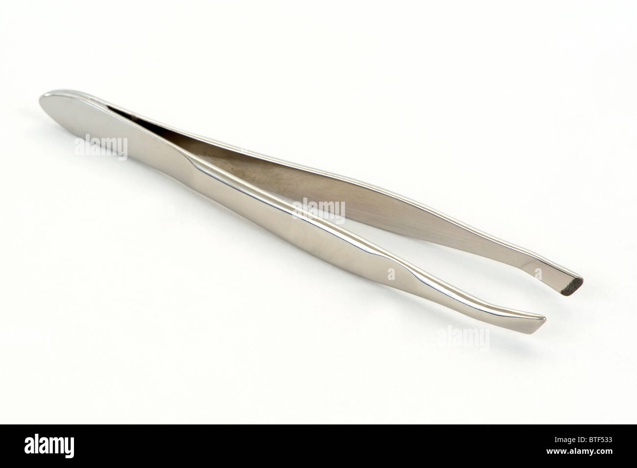 stainless steel grooming tweezers on a white background Stock Photo - Alamy
