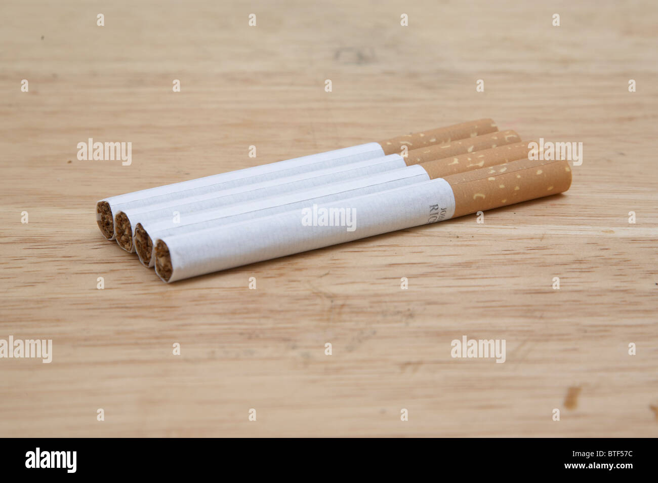 Cigarettes sitting next to each other in a line Stock Photo - Alamy