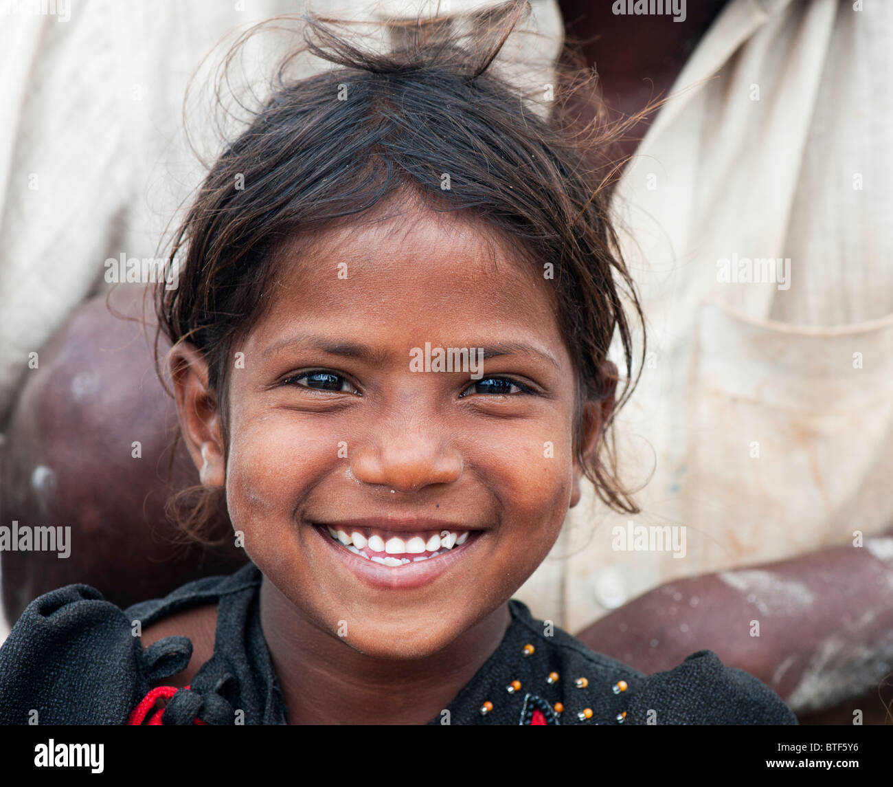 Young poor indian street girl with a big happy smile. Andhra Pradesh ...