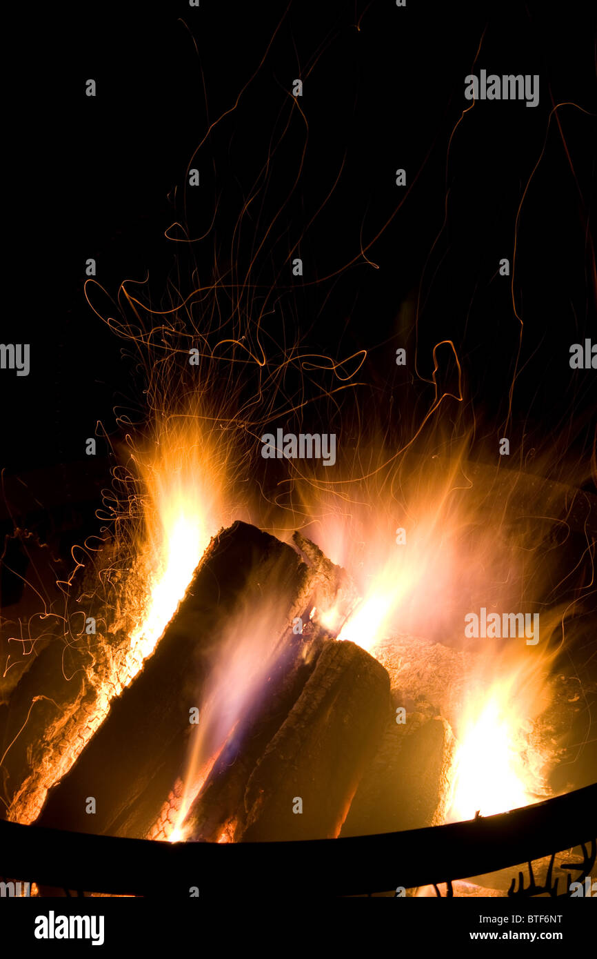 Camp Fire Giving Off Sparks at Night - Burning Wood Stock Photo - Alamy