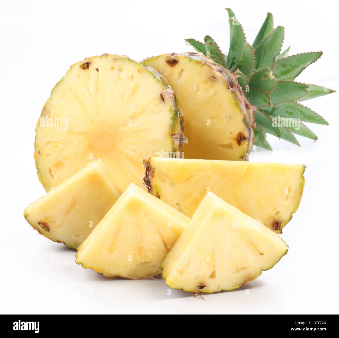 Cut ripe pineapple with rich green rosette. Isolated on a white Stock ...