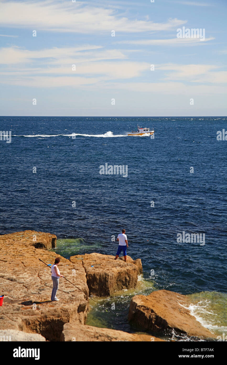 Two anglers fishing from the shoreline hi-res stock photography and ...
