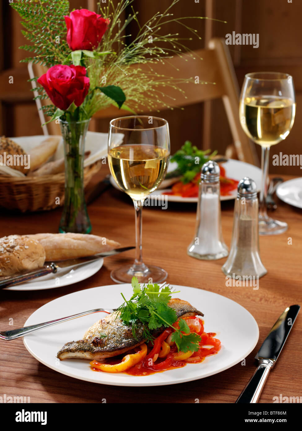 Sea bass in a restaurant table setting Stock Photo - Alamy