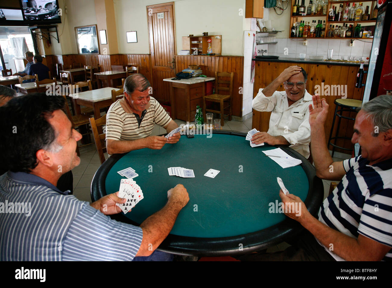 Men playing cards at a traditional men's cafe in Pothia, Kalymnos ...
