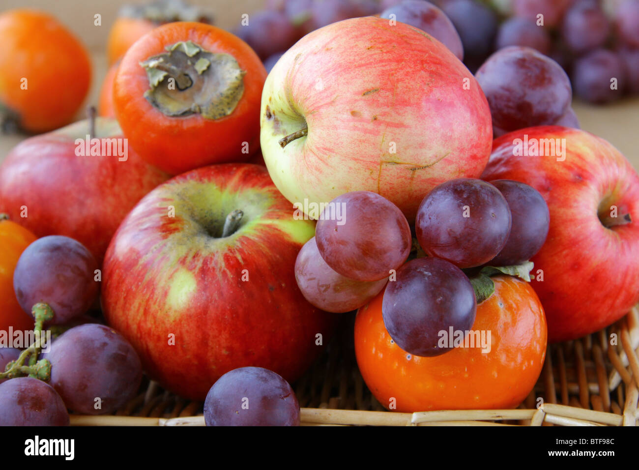 Fruity mix of many apples, persimmons, grapes Stock Photo - Alamy