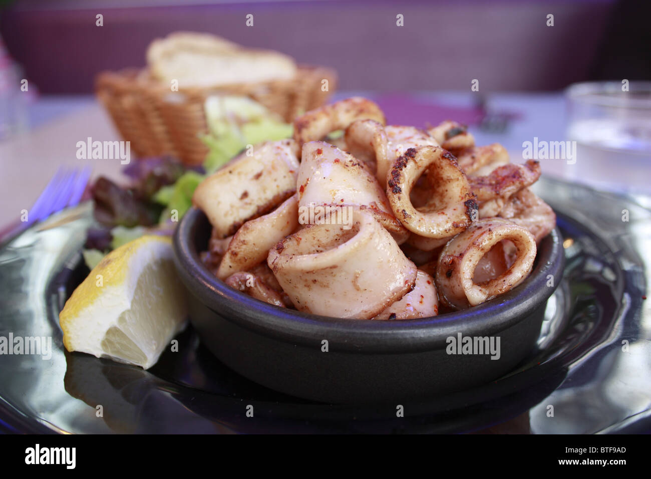Gastronomy specialty, tapas of cutting cuttle-fish with Espelette red ...