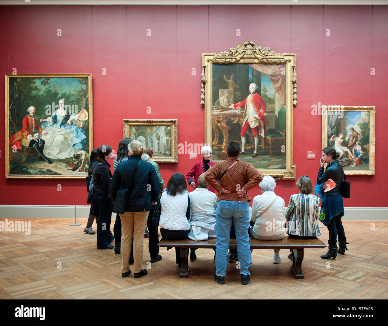 Tour group listening to art guide at Metropolitan Museum of Art in ...