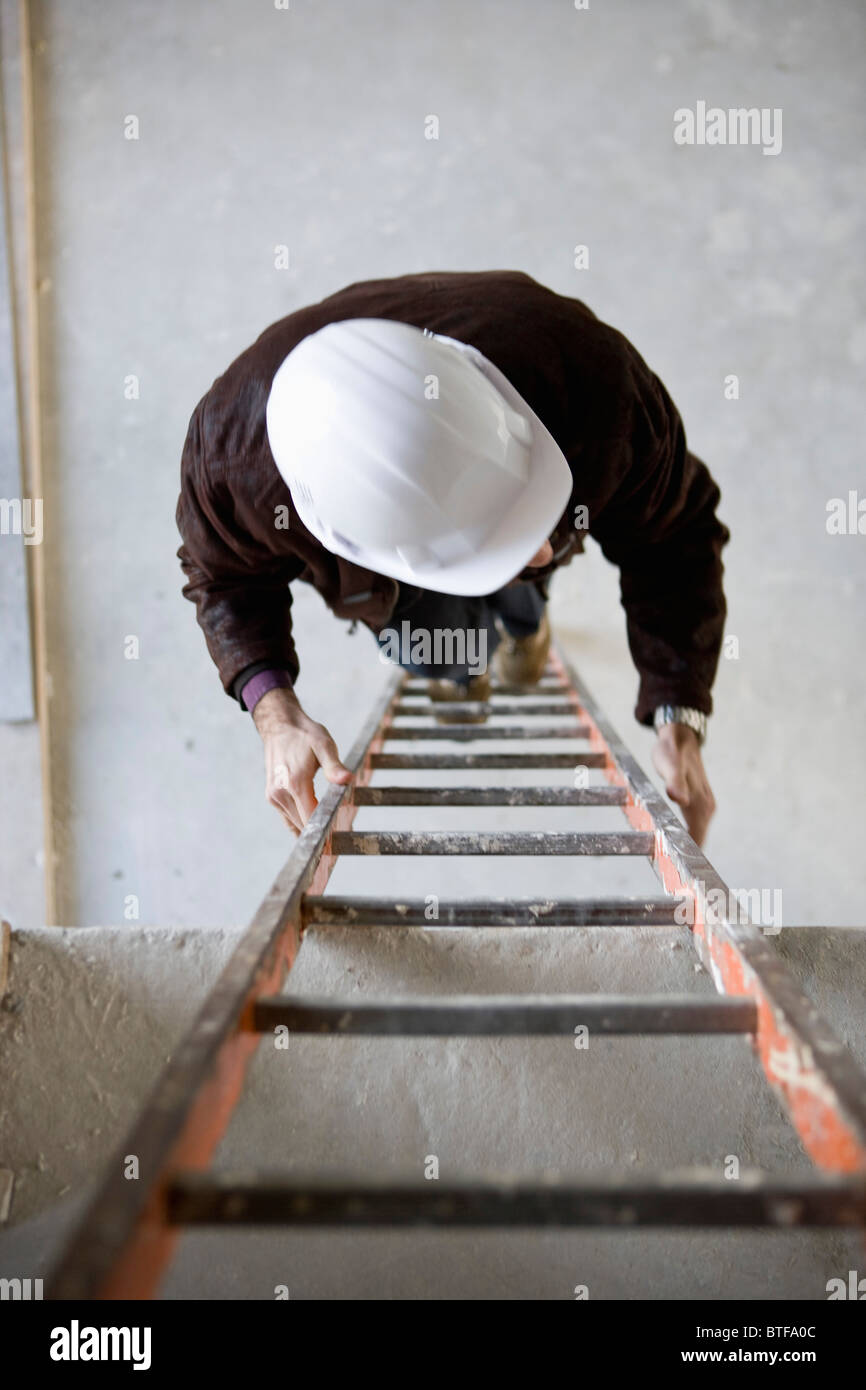 Construction worker climbing ladder Stock Photo - Alamy