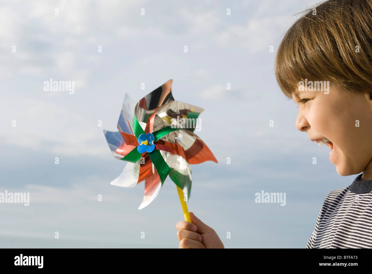 Boy playing with pinwheel Stock Photo - Alamy