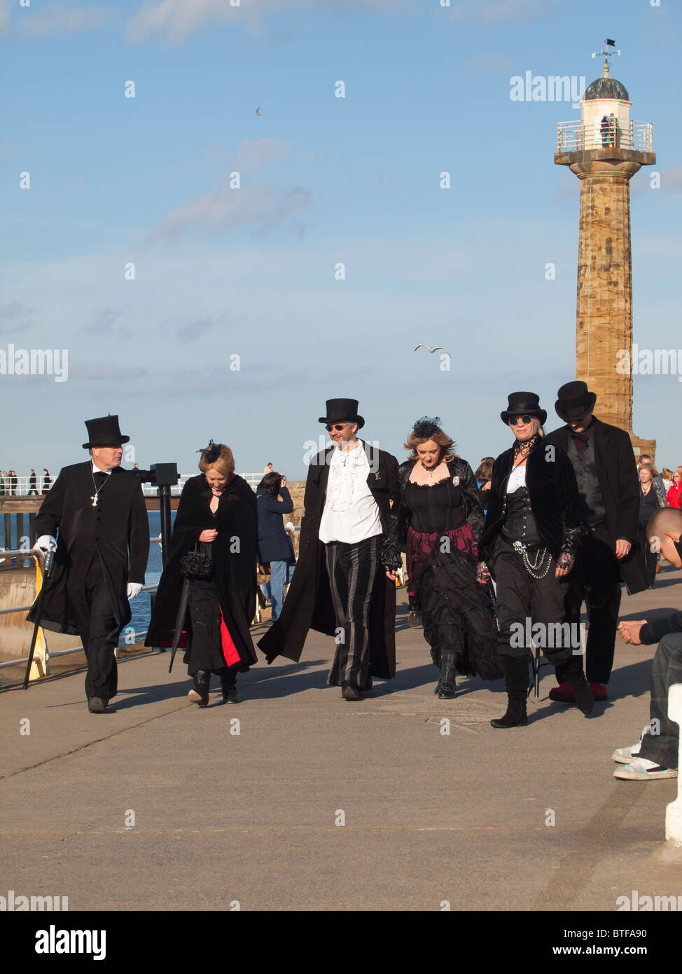 A group of people dressed as Goths on the pier at the Whitby Goth Week ...
