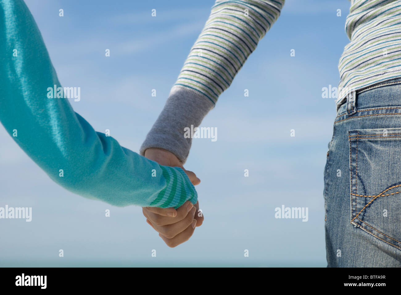 Two parents holding childs hand hi-res stock photography and images - Alamy