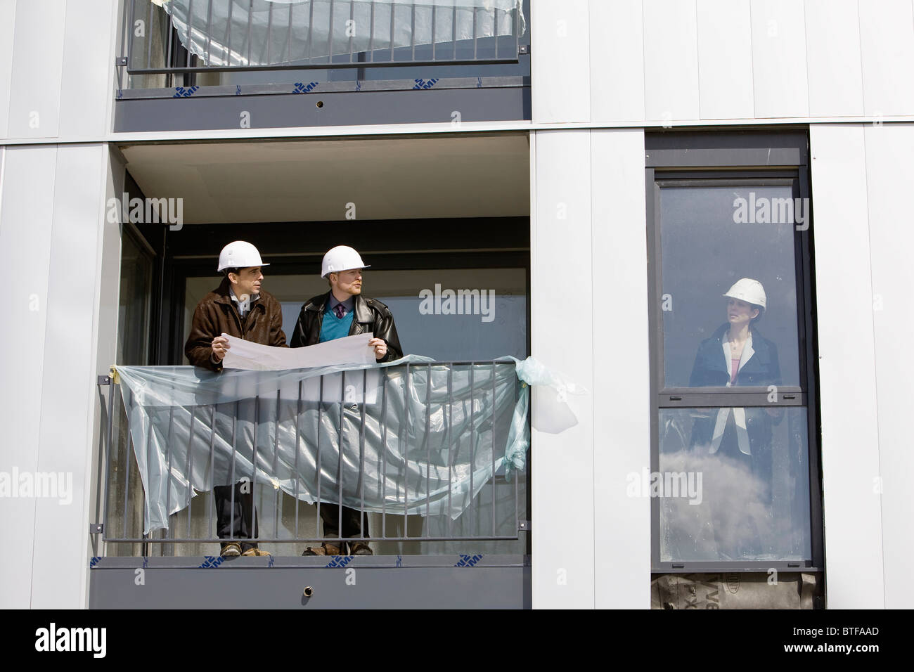 Property developer meeting with business people at building under ...