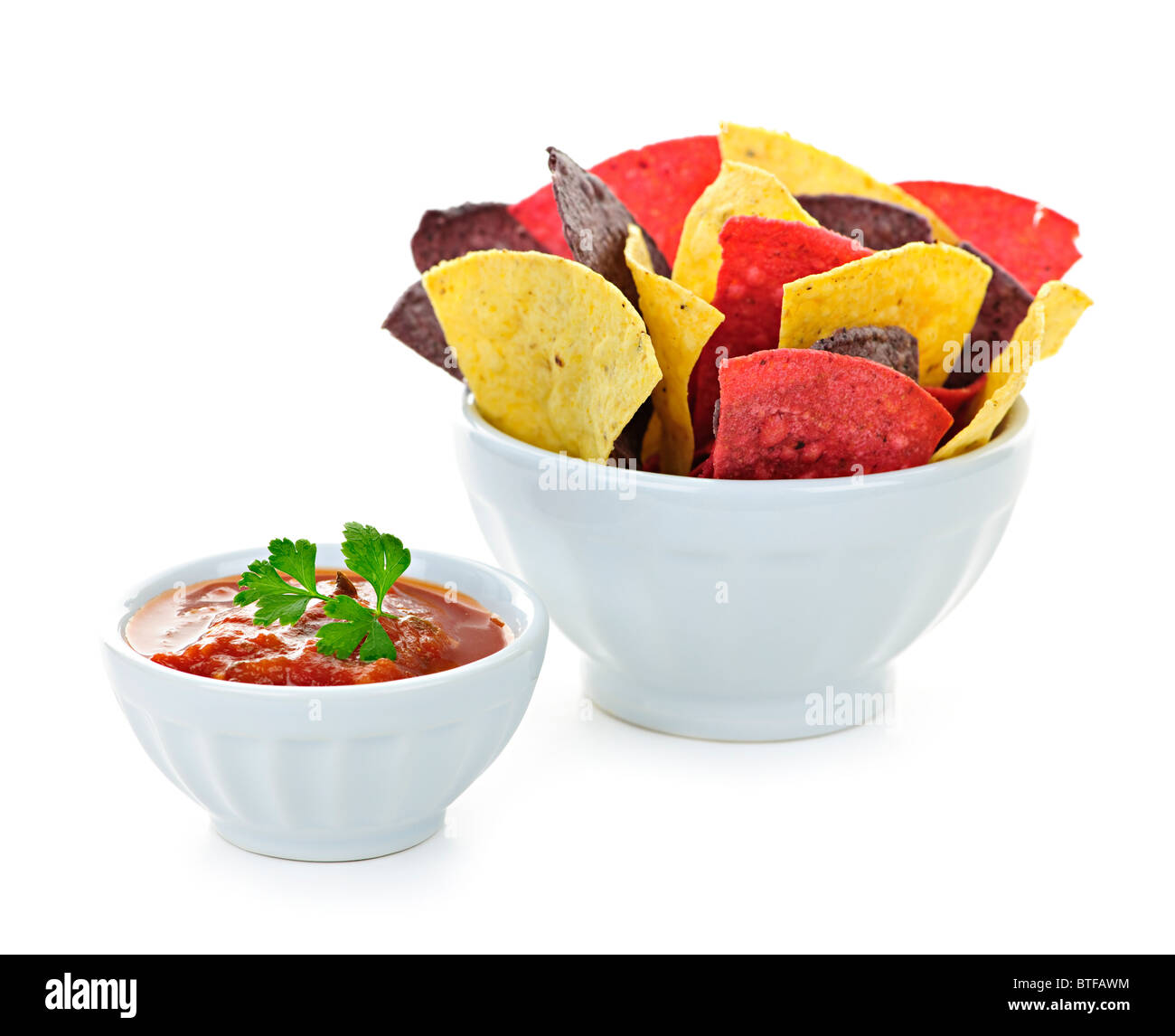 Bowl of salsa with colorful tortilla chips isolated on white background ...