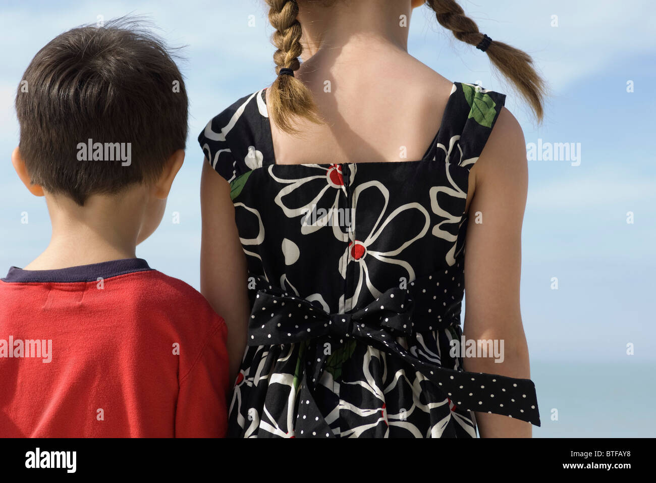 Siblings together outdoors, rear view Stock Photo - Alamy