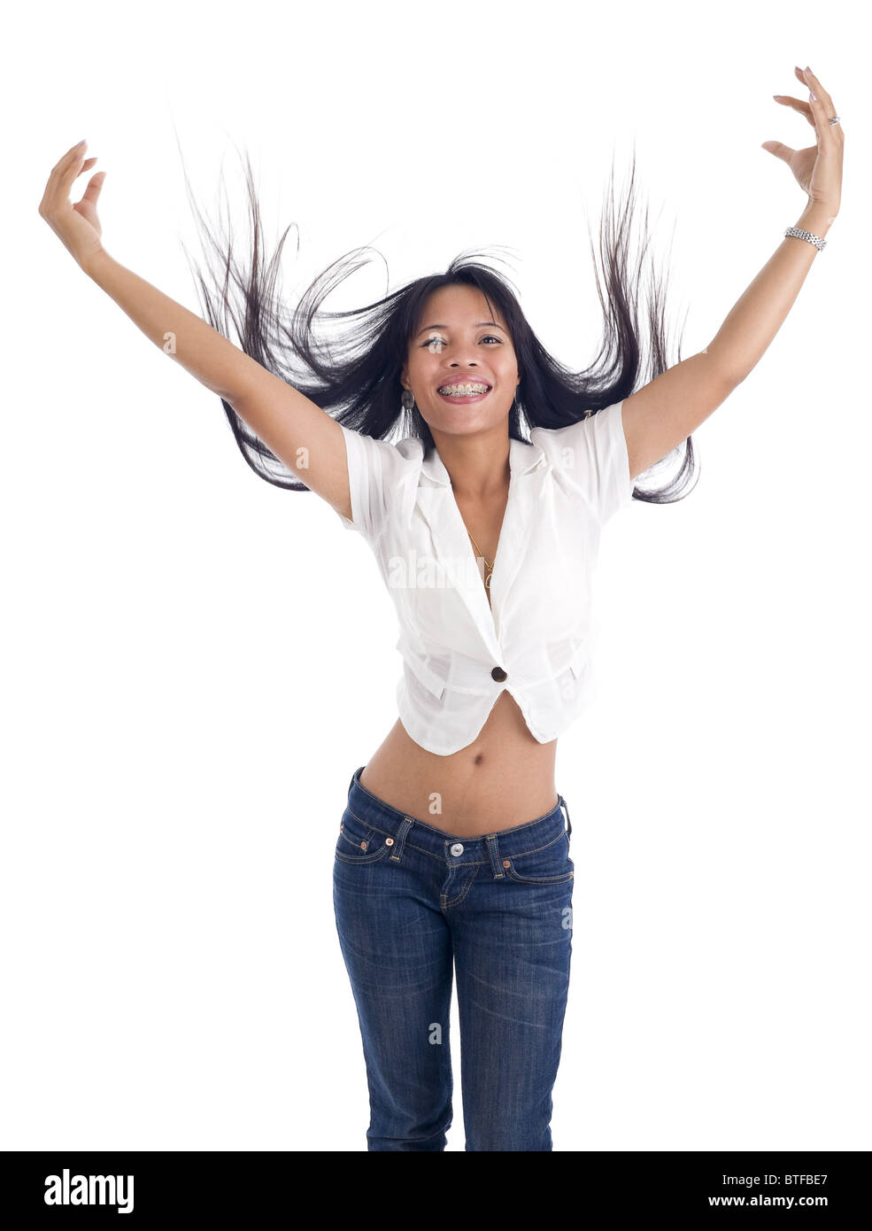young asian woman with braces in a windy studio, isolated on white ...