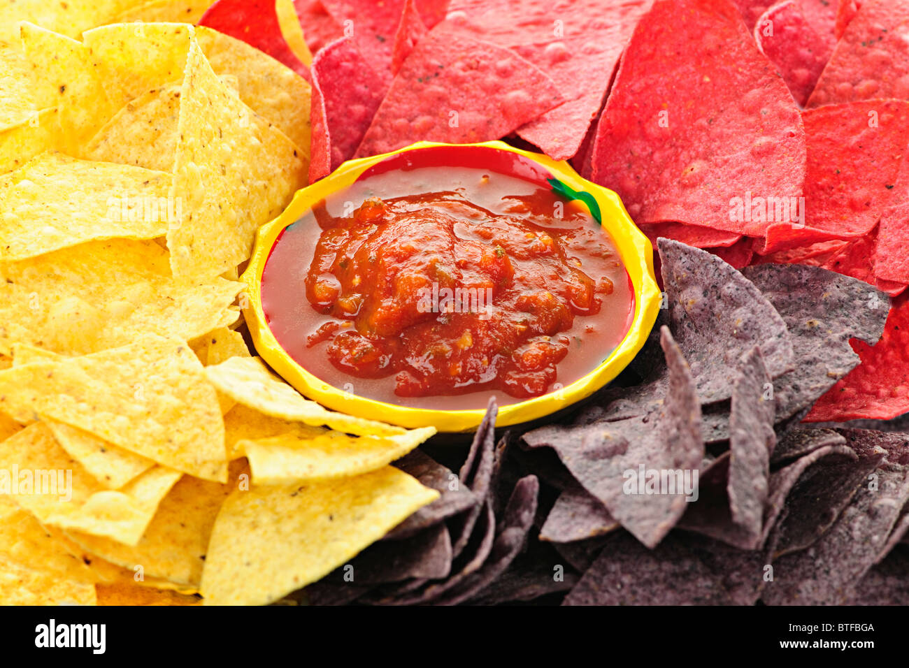 Bowl of salsa with colorful tortilla chips Stock Photo - Alamy