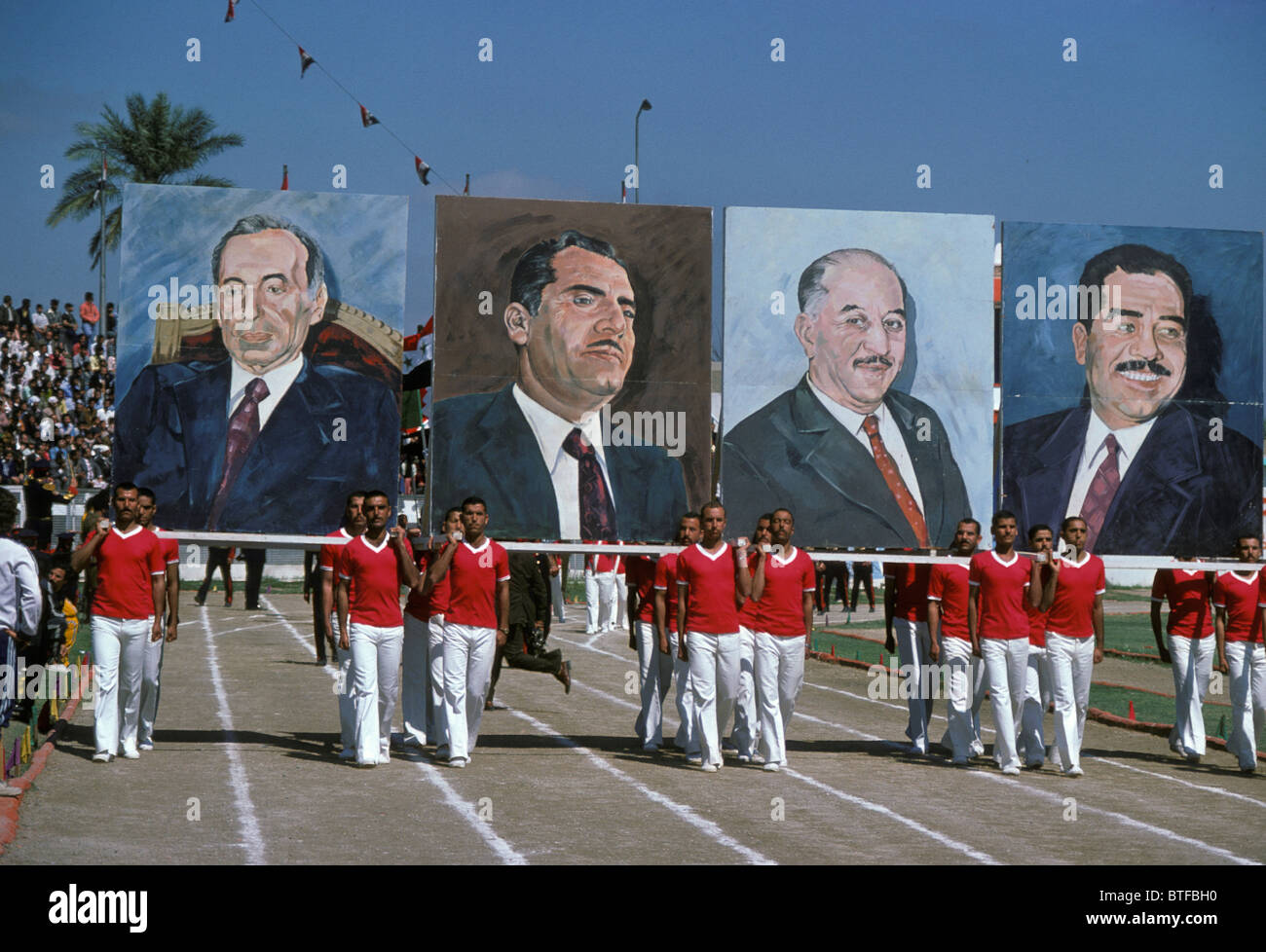 Giant portraits of Iraqi leaders,inc. Saddam Hussein are paraded Stock ...