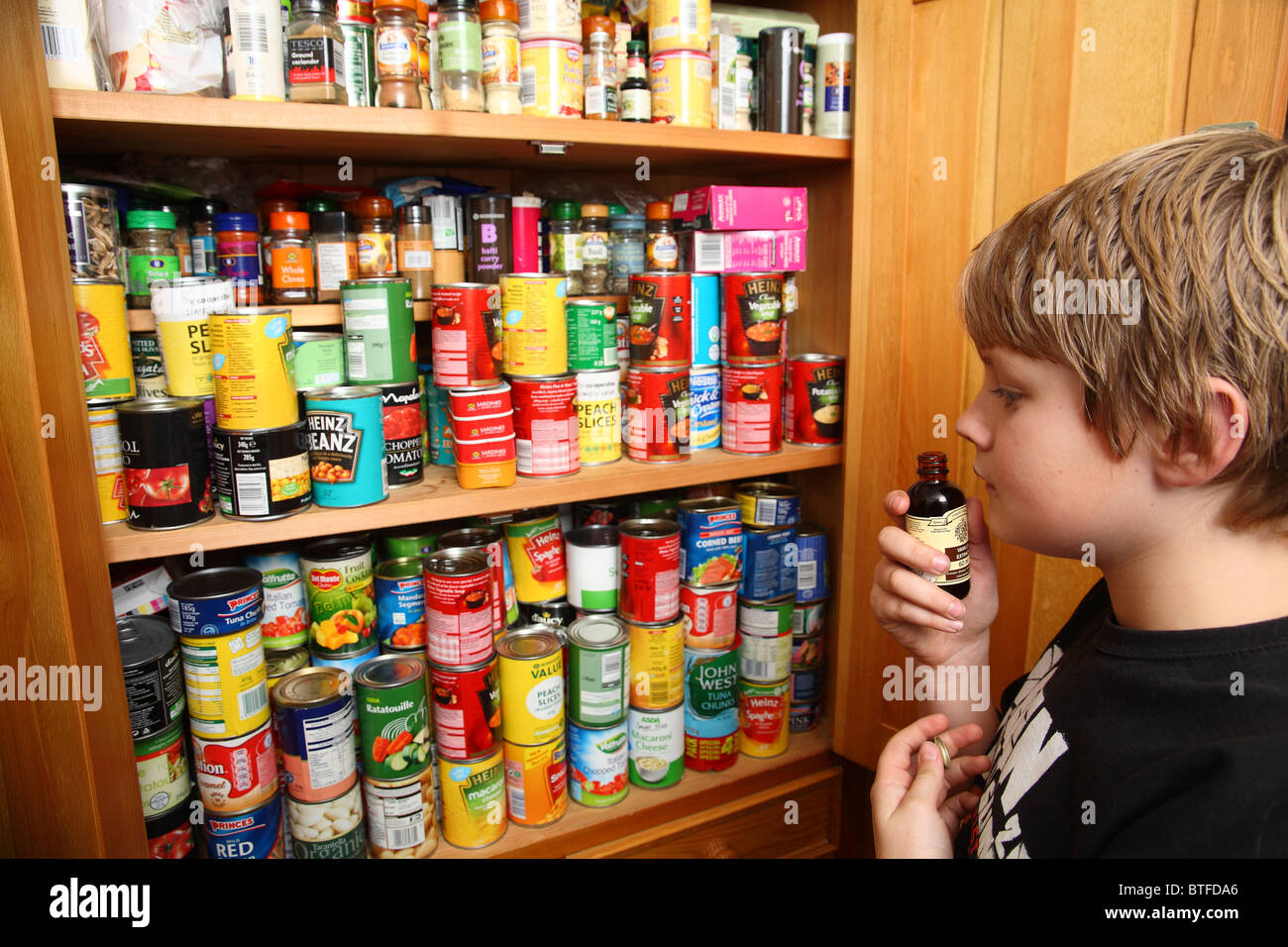 boy sniffing essence from food cupboard Stock Photo - Alamy