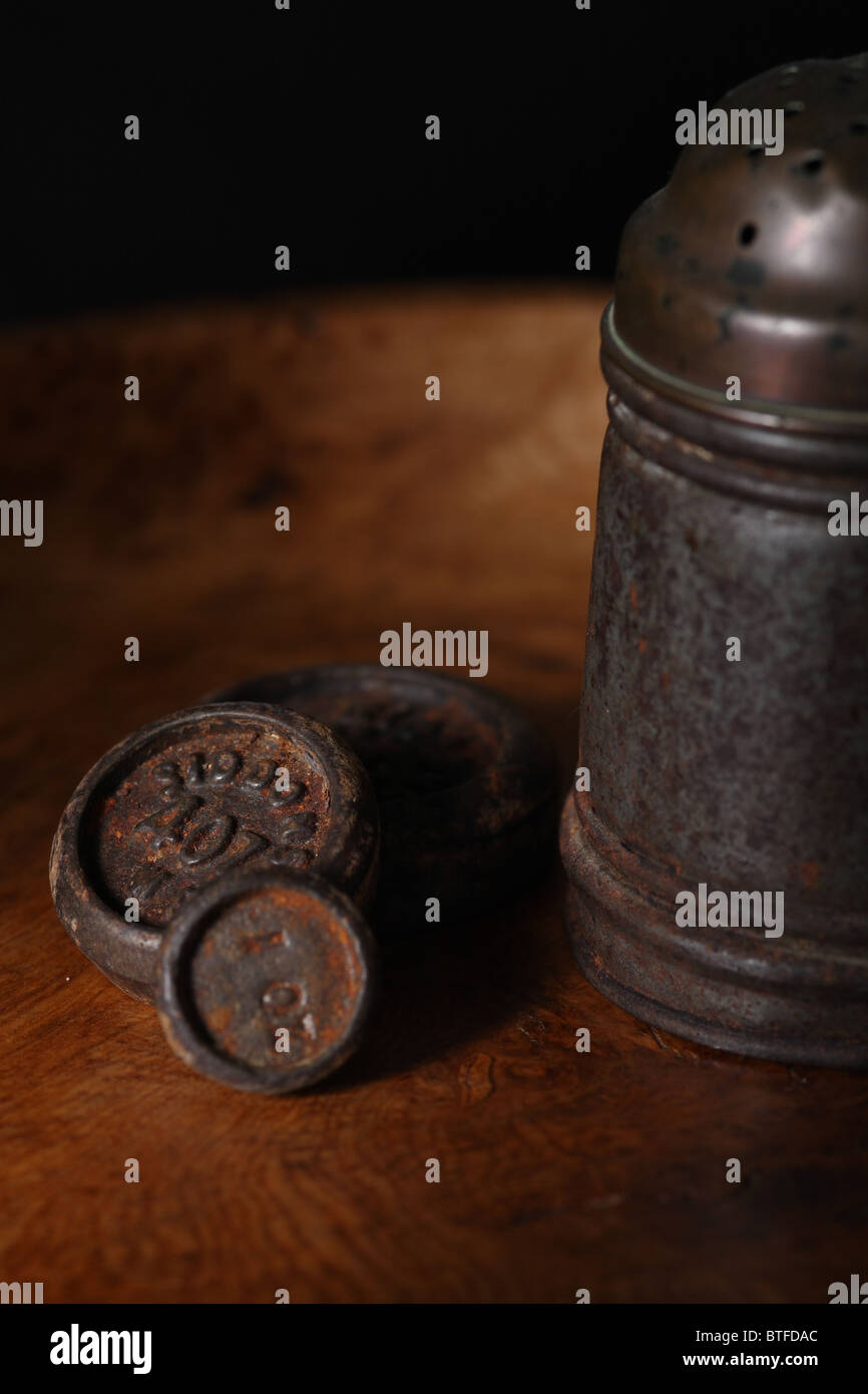 kitchen scale weights and old salt shaker Stock Photo - Alamy
