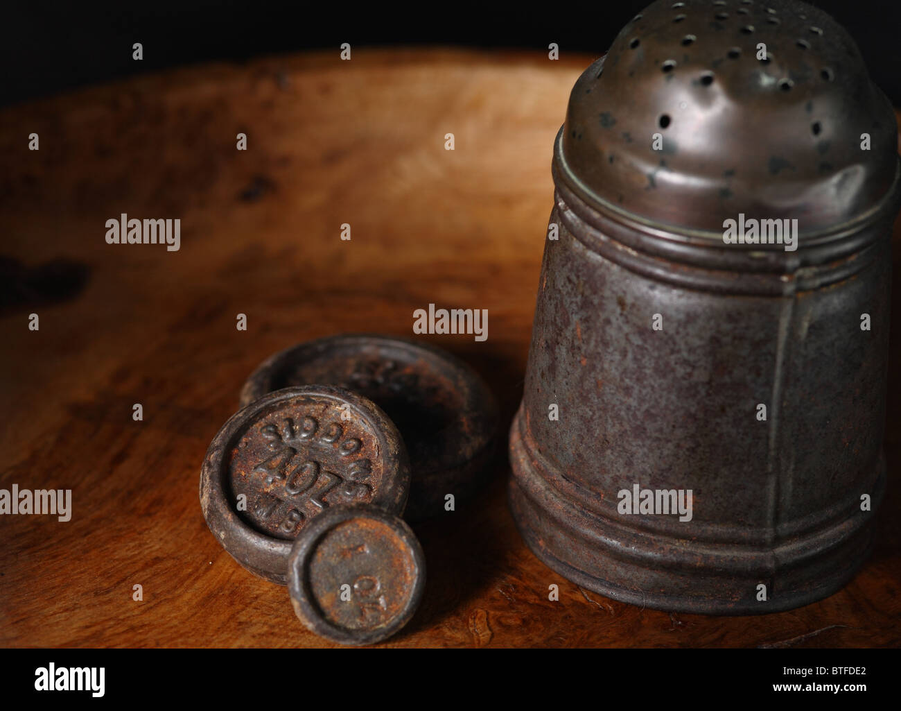 kitchen scale weights and old salt shaker Stock Photo - Alamy