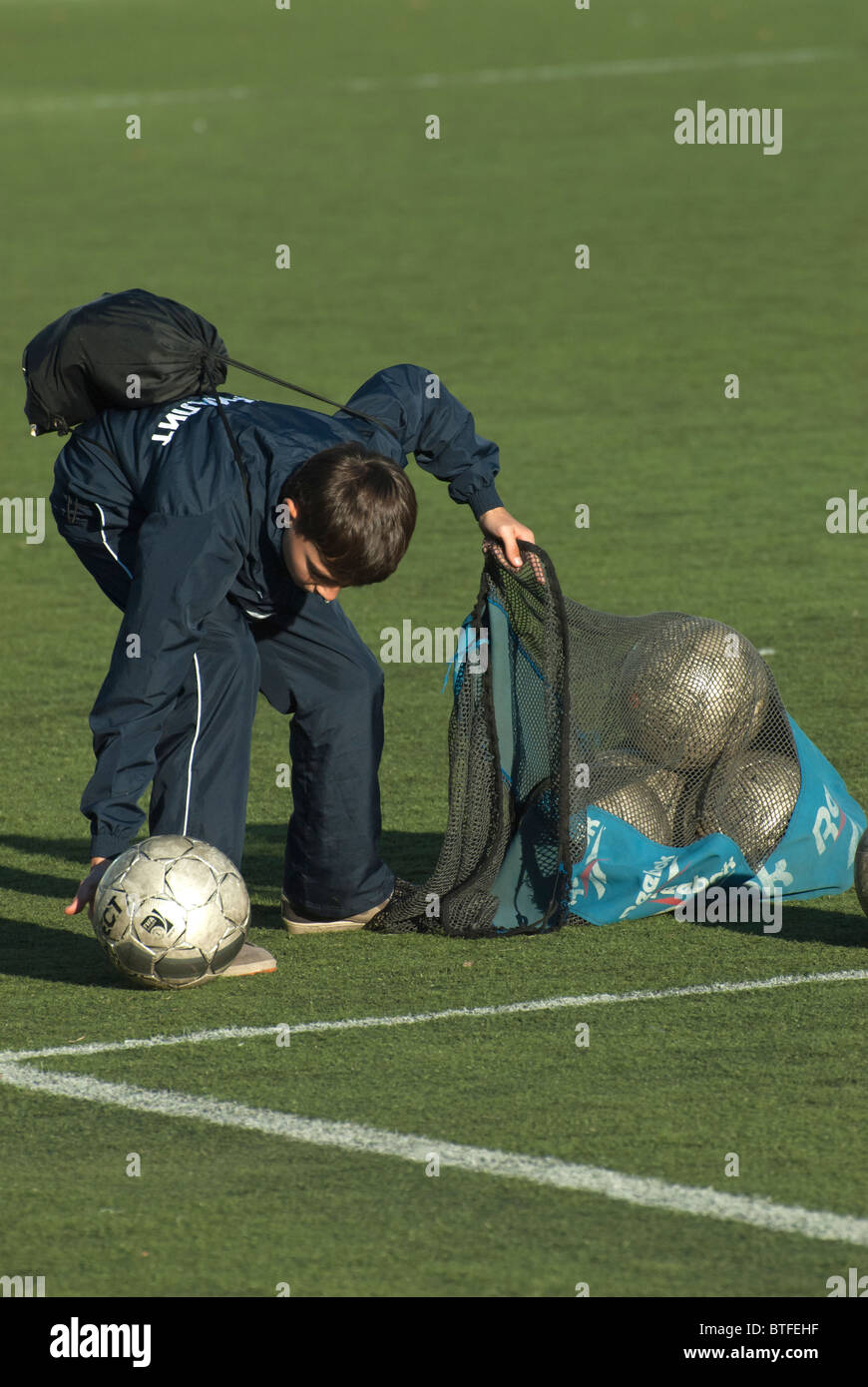 A little boy collecting the balls after the end of match Stock Photo ...