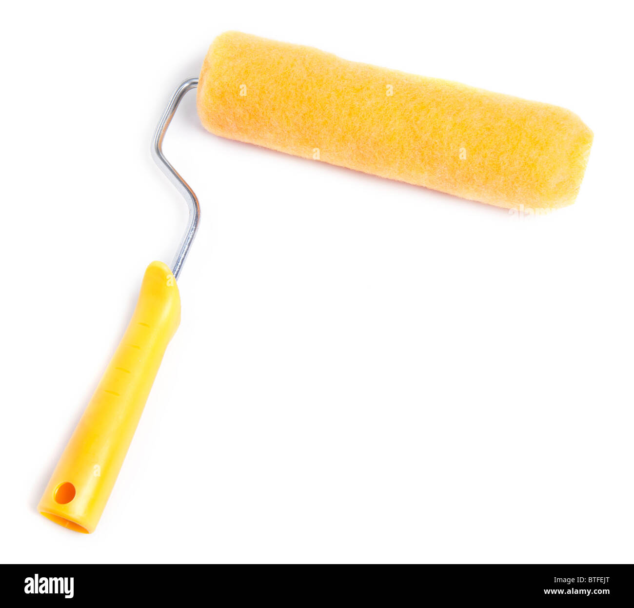 Yellow paint roller against white studio background Stock Photo - Alamy