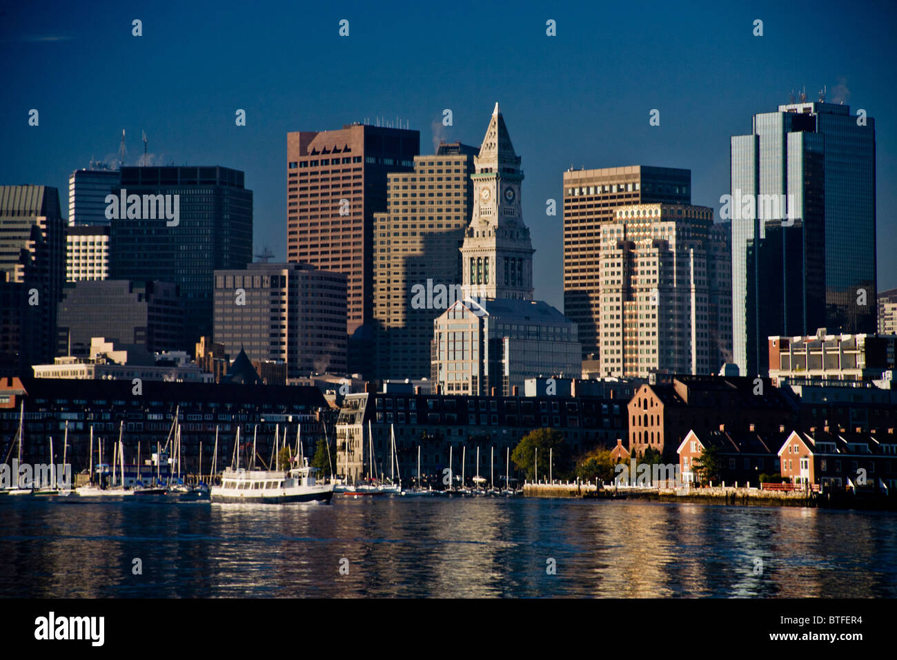 Morning sun shines on the downtown Boston harbor skyline as seen from ...