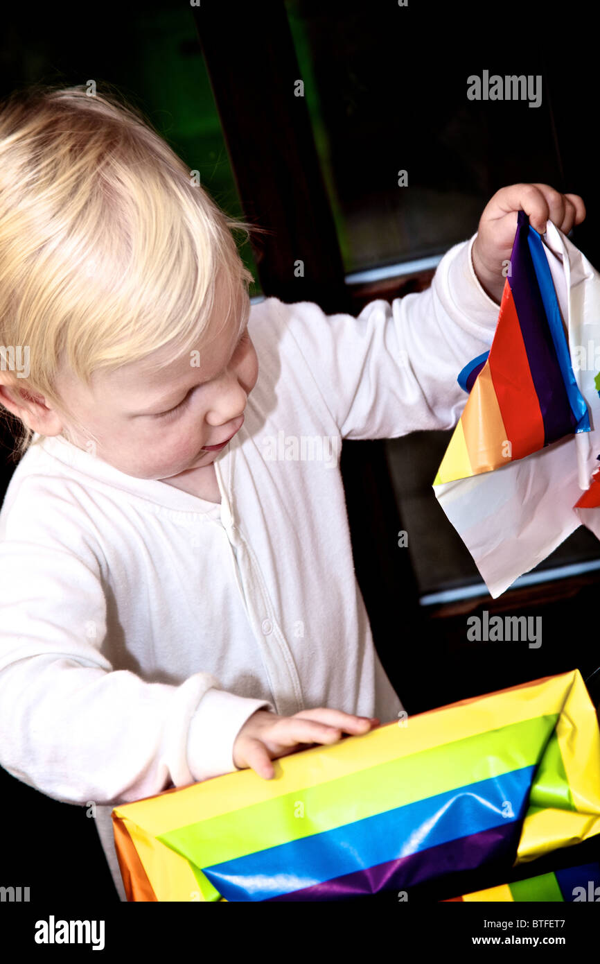 child unwrapping a present Stock Photo - Alamy
