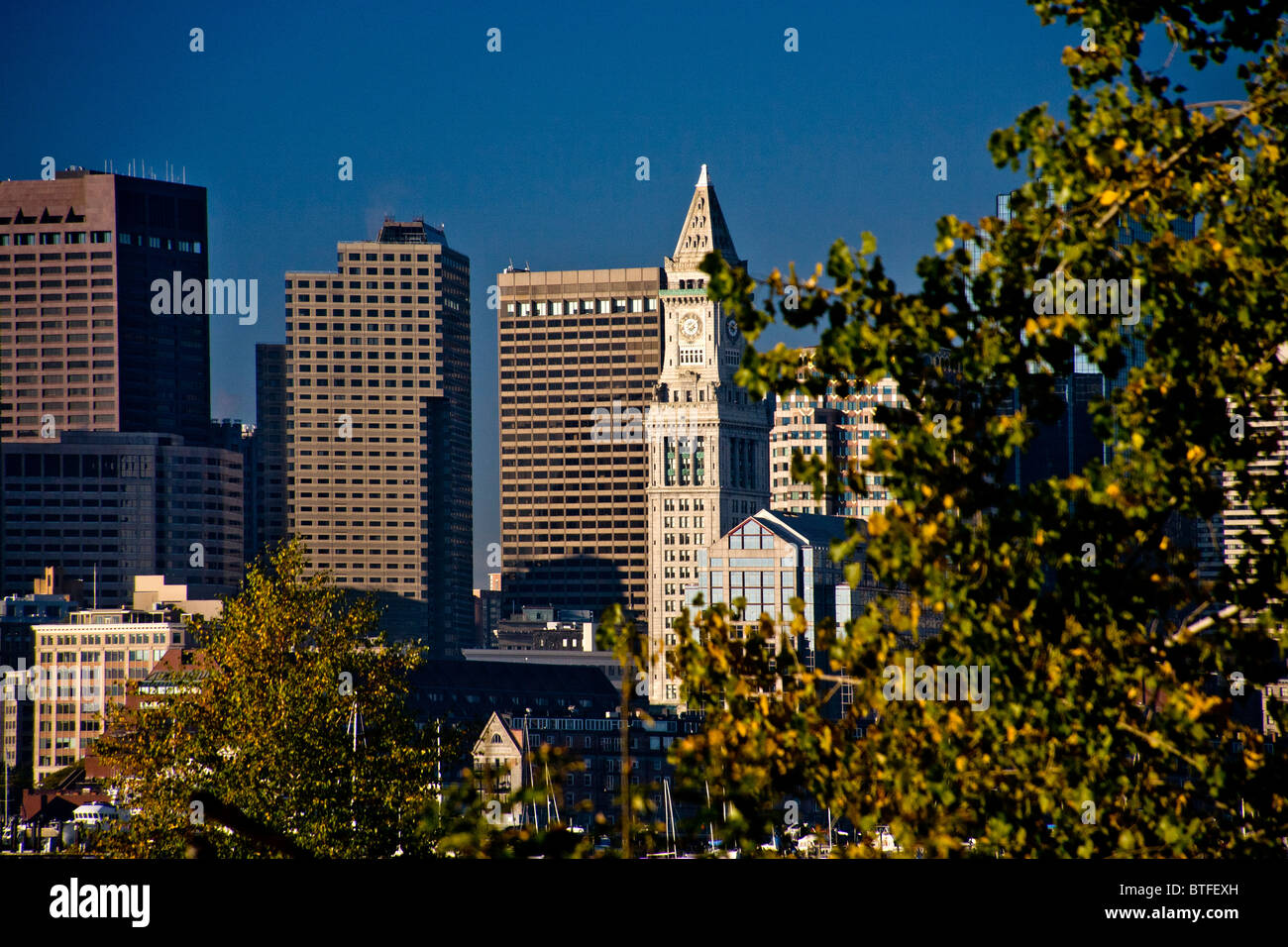 Morning sun shines on the downtown Boston harbor skyline as seen from ...