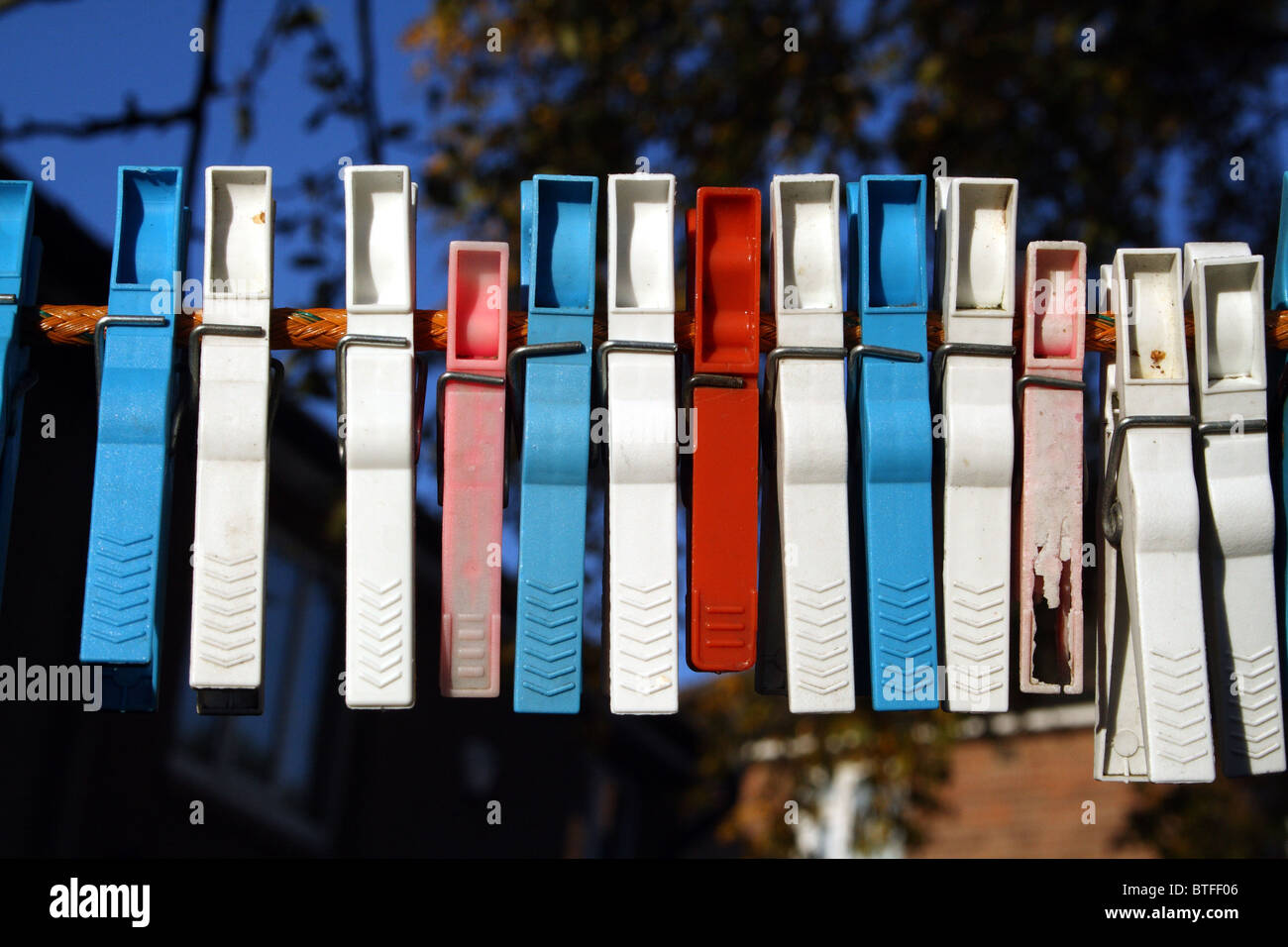 Colourful clothes pegs on a washing line Stock Photo - Alamy