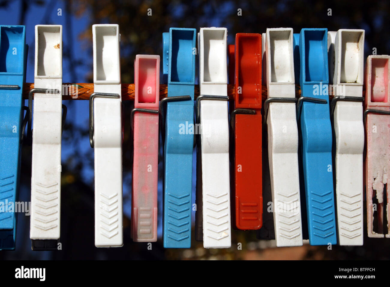 Colourful clothes pegs on a washing line Stock Photo - Alamy