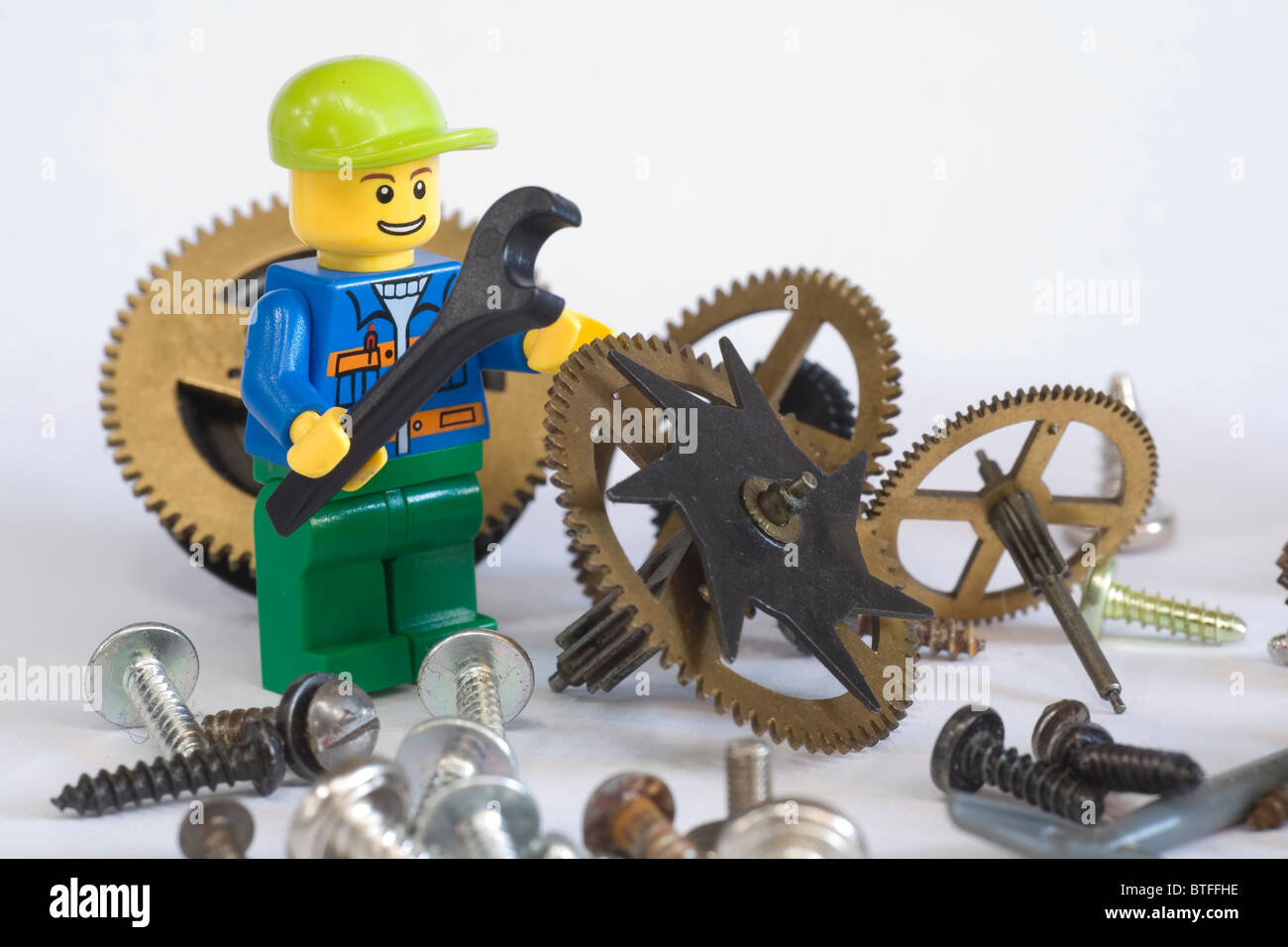 Lego workman with giant spanner working on machinery and cogs Stock ...