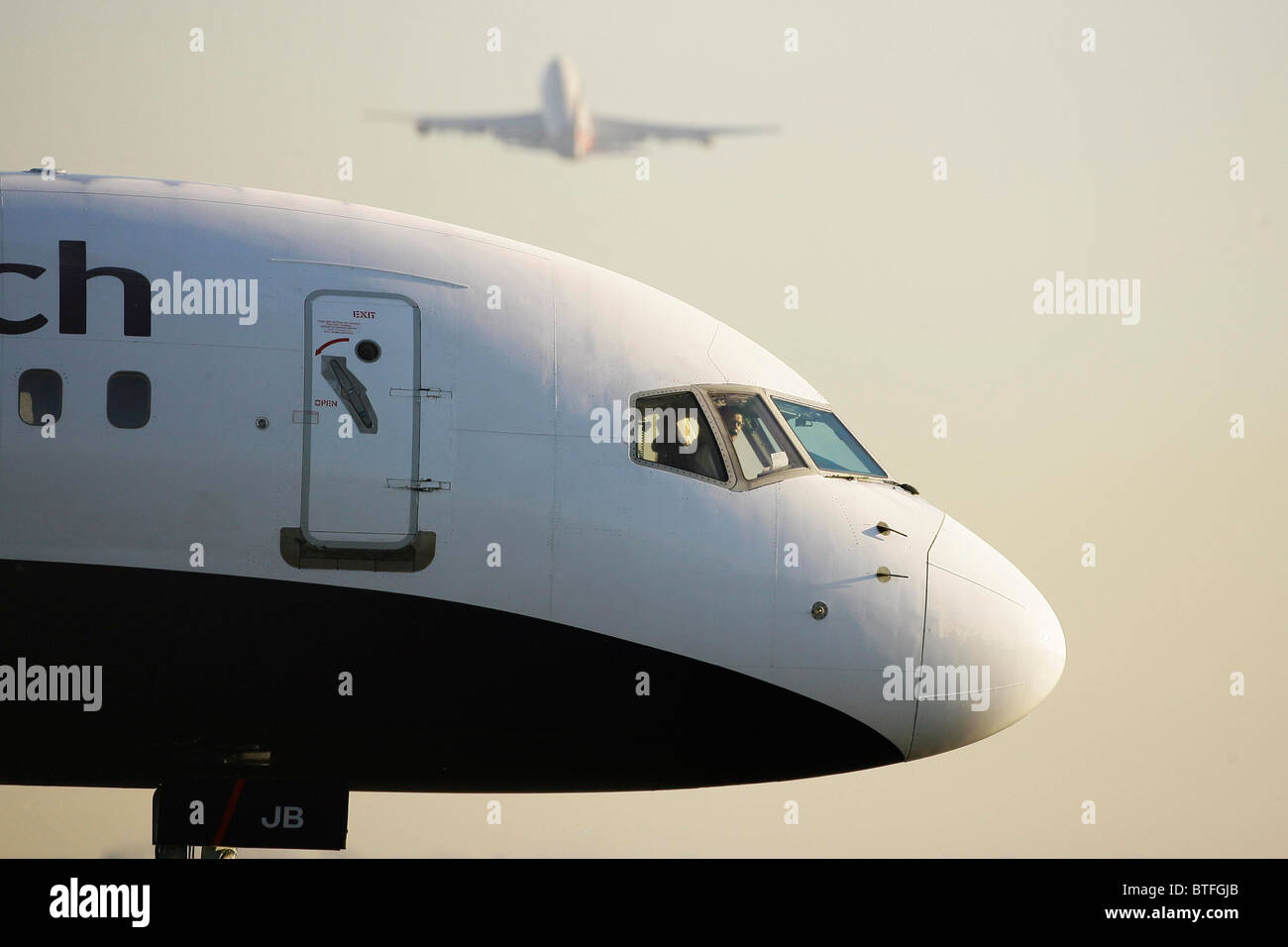 A Pilot and first officer look out of the flight deck windshield as ...