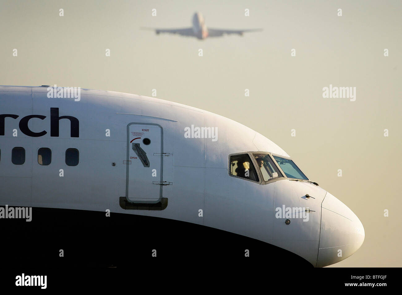 A Pilot and first officer look out of the flight deck windshield as ...