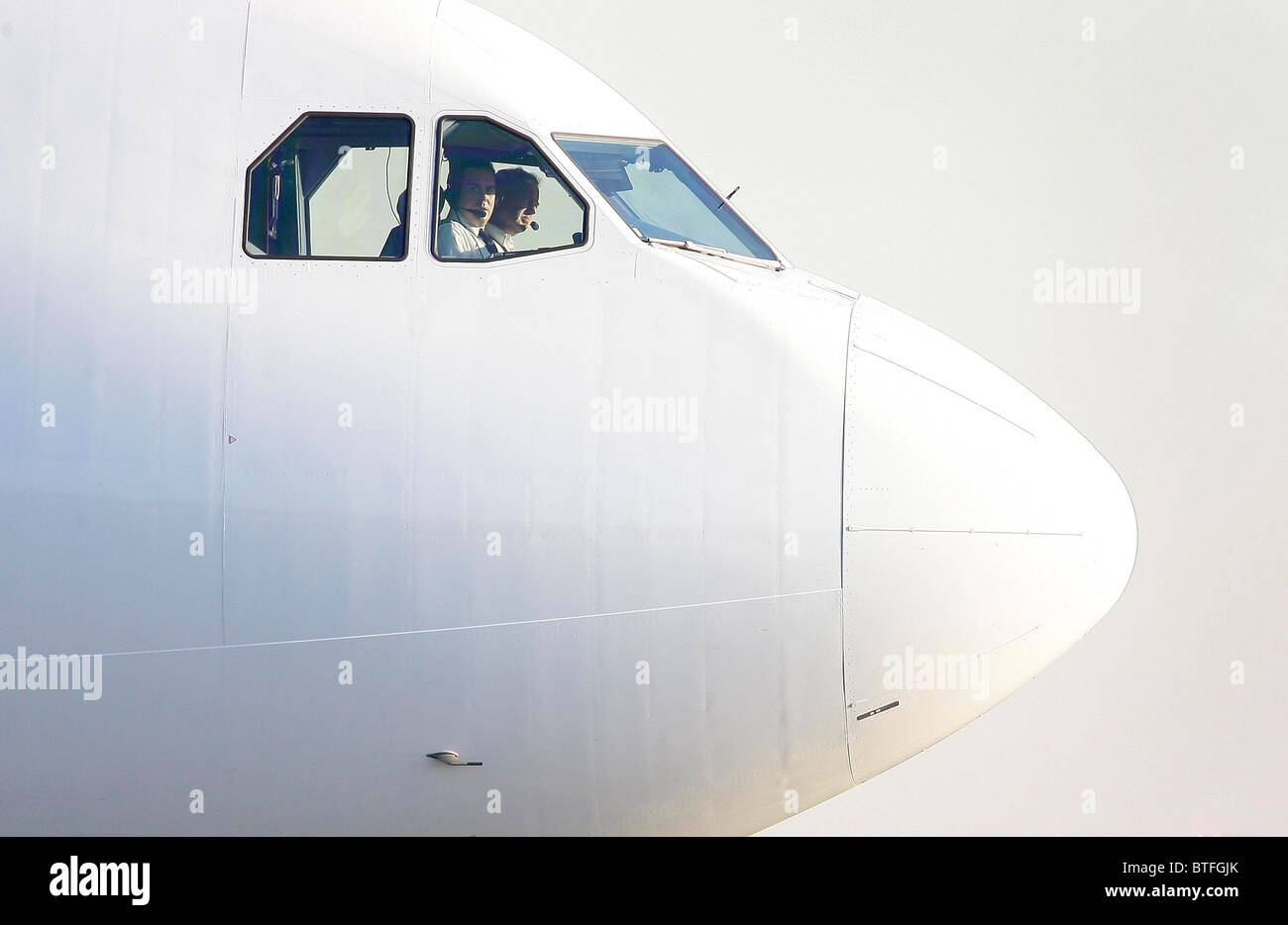 A Pilot and first officer look out of the flight deck windshield as ...