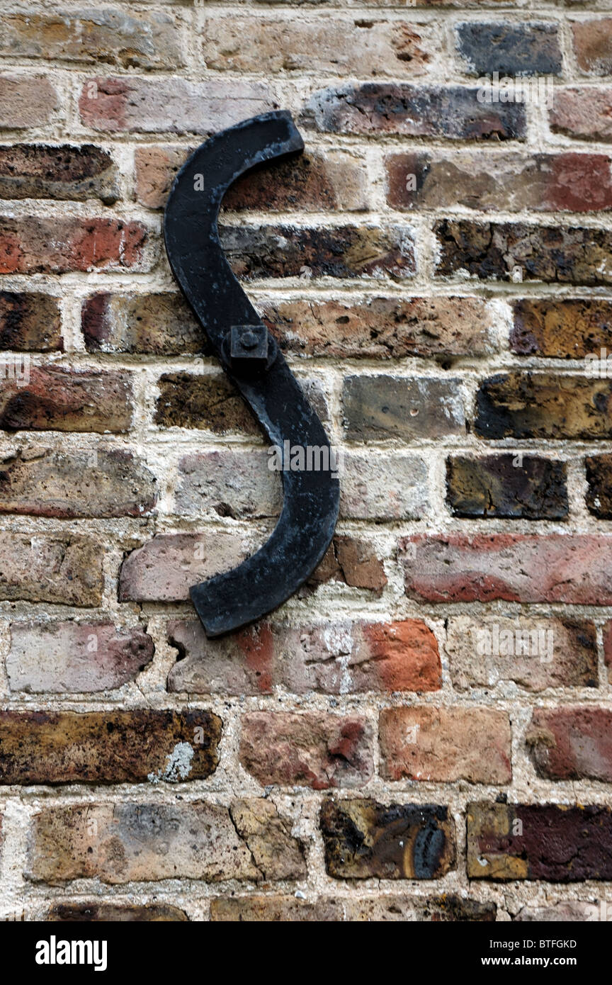 S shaped patress plate on a brick wall in a house in Frampton-on-Severn ...