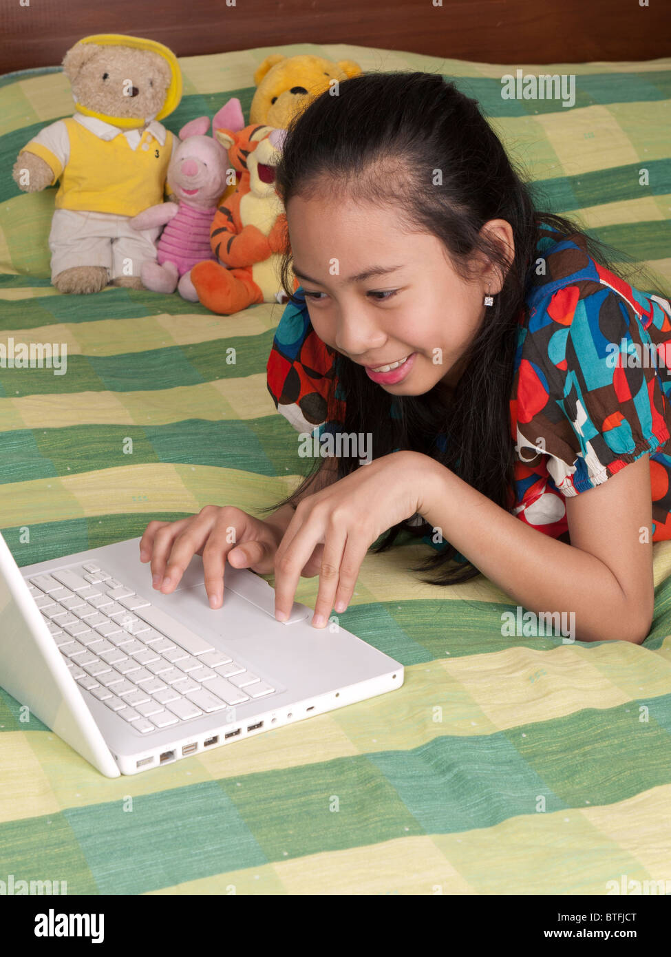 A teenage girl uses a computer in her room Stock Photo - Alamy