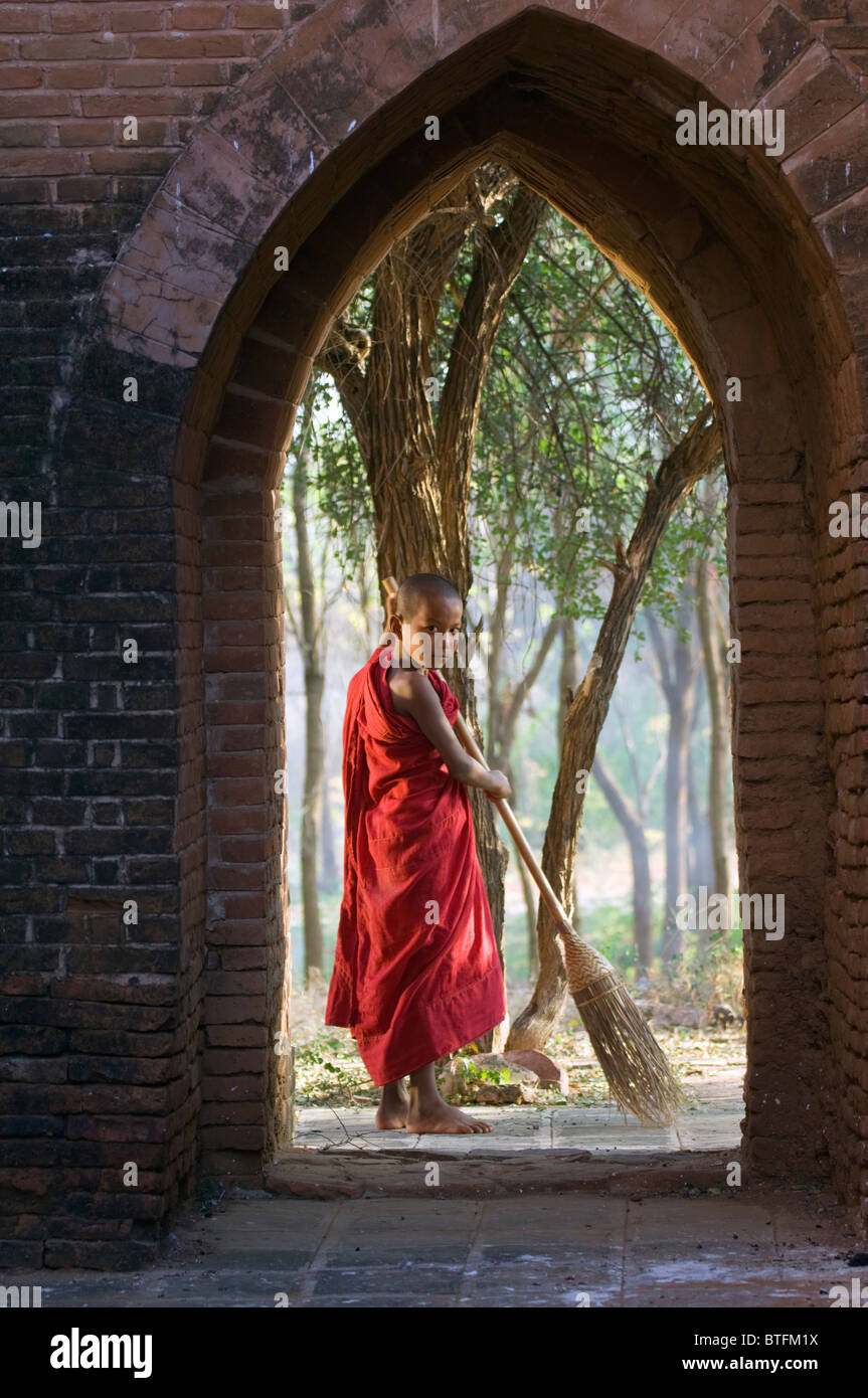 Novice Buddhist monk sweeping out leaves, Bagan (Pagan), Myanmar (Burma ...