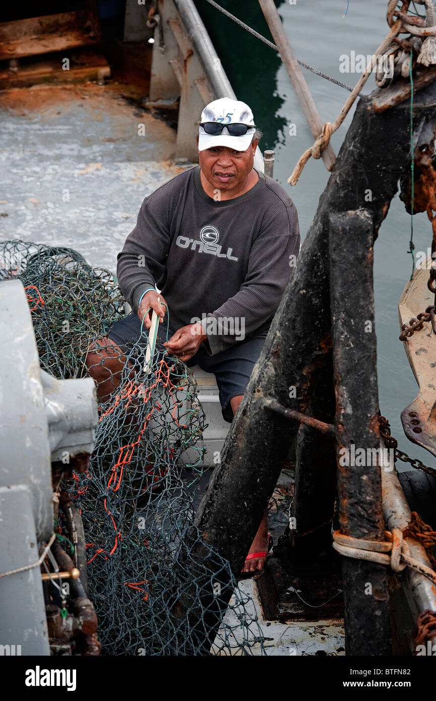 Repairing the damaged nets Stock Photo - Alamy