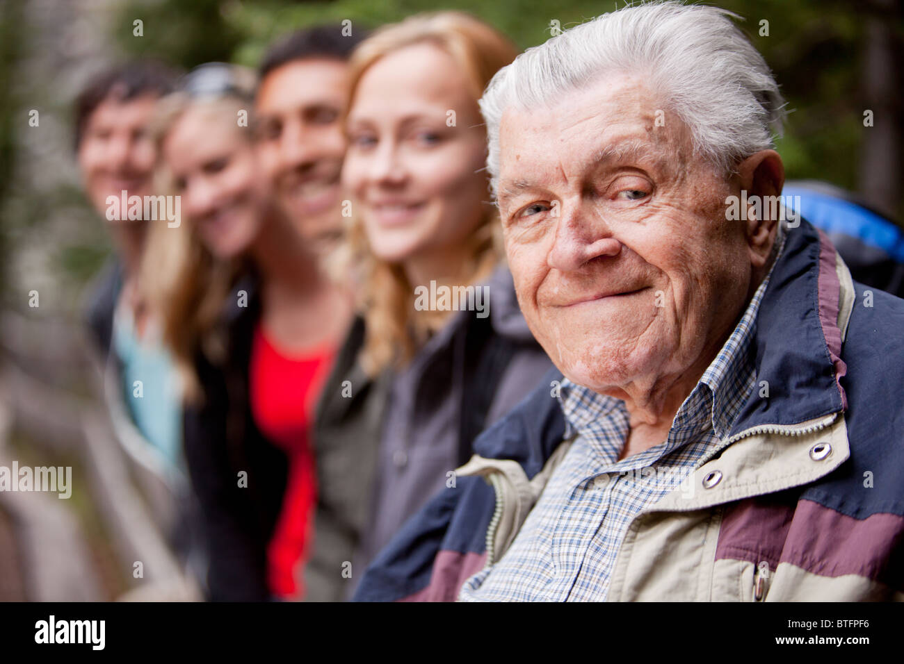 An Elderly Man In Front Of A Group Of Young People Stock Photo Alamy an-elderly-man-in-front-of-a-group-of-young-people-stock-photo-alamy