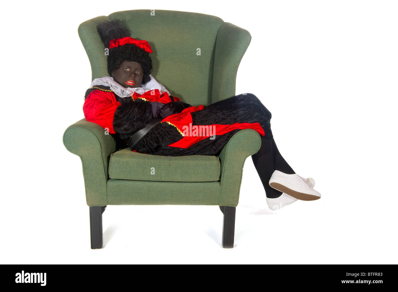 Black Piet lazy laying in chair in the studio Stock Photo - Alamy