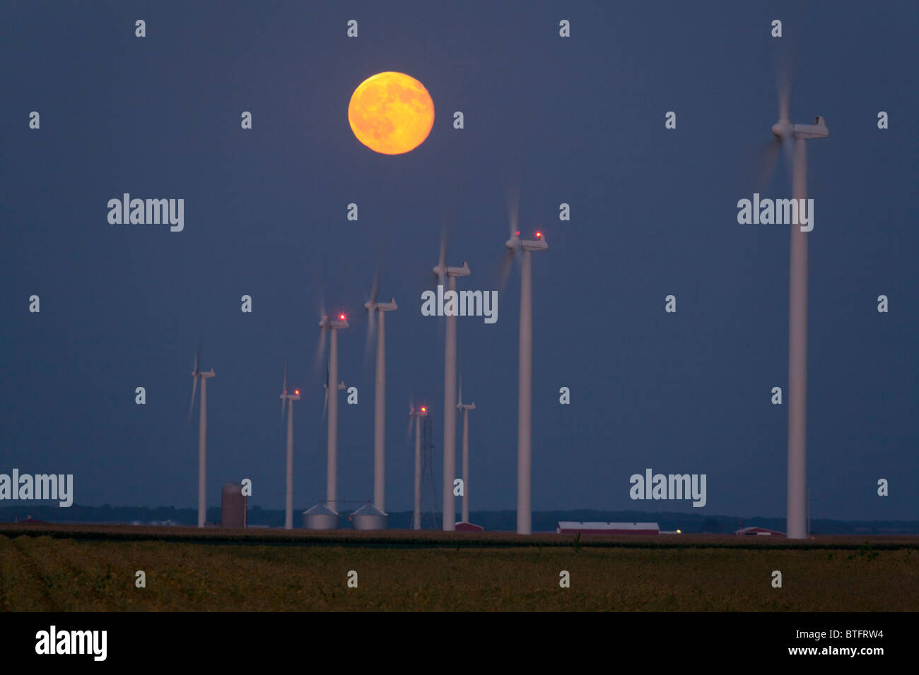 Moonrise over a wind farm at twilight Stock Photo - Alamy